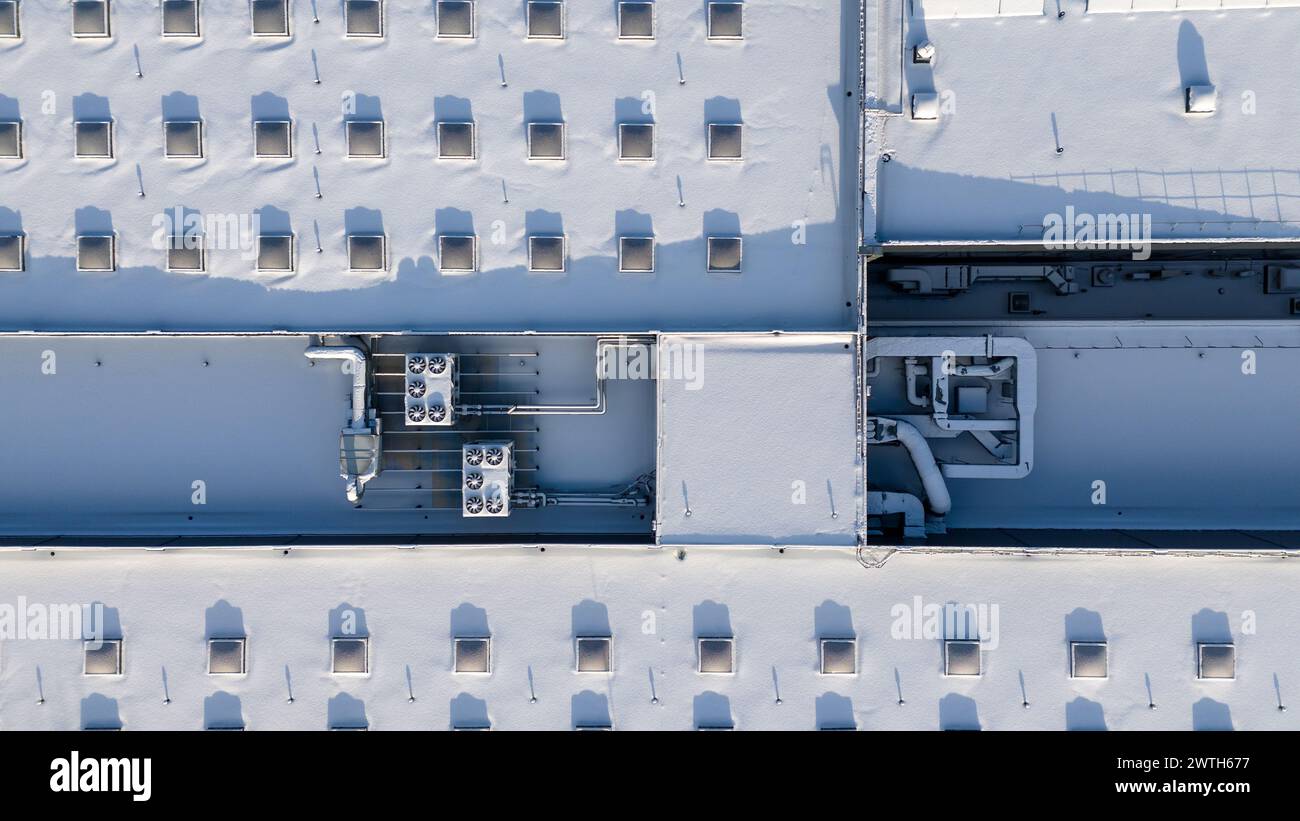 Drone photography of a large building rooftop with skylights covered by ...
