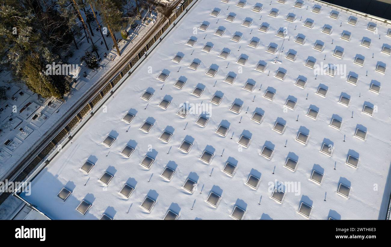 Drone photography of a large building rooftop with skylights covered by ...