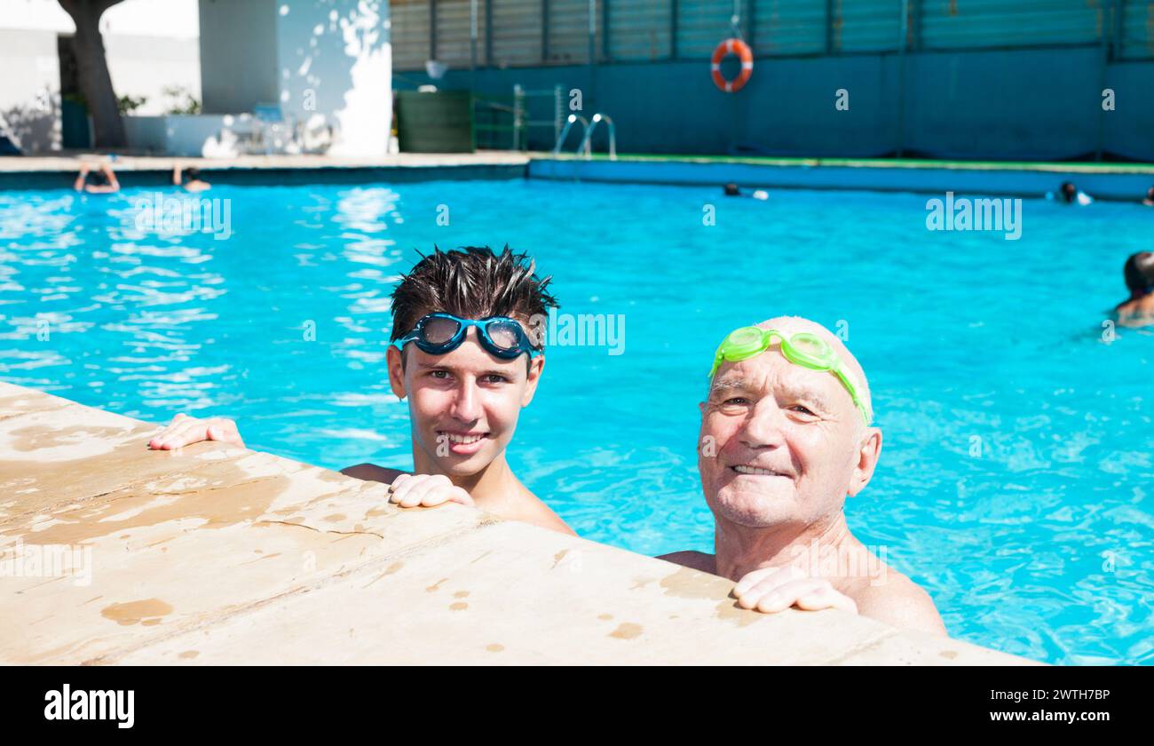 Grandfather and grandson communicate in swimming pool Stock Photo - Alamy