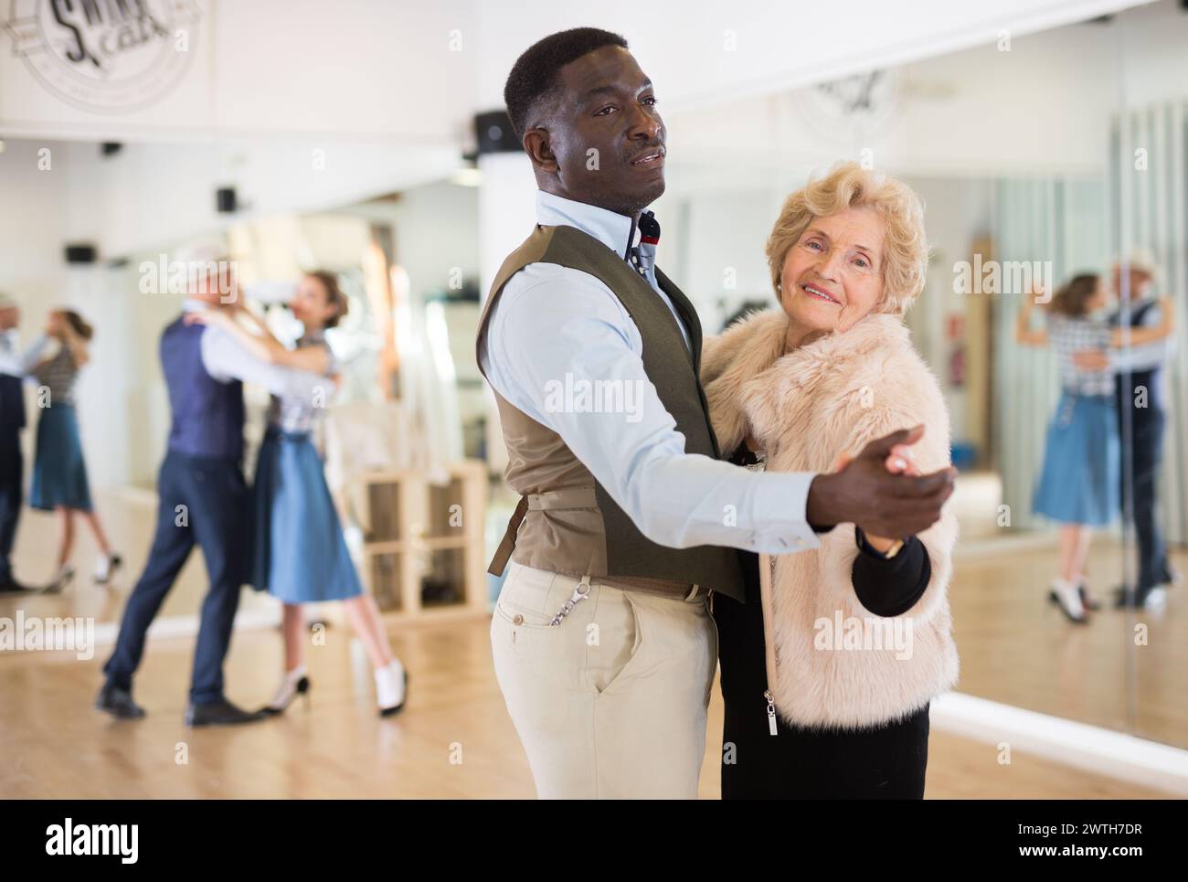 Man and mature woman learning to dance classical ballroom dance Stock ...