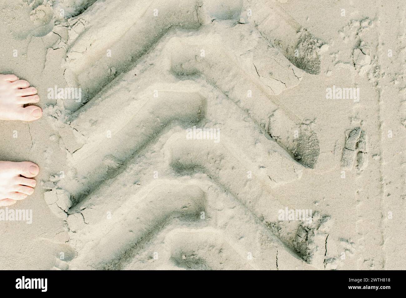 Feet and Tire Tracks in Sand Stock Photo - Alamy
