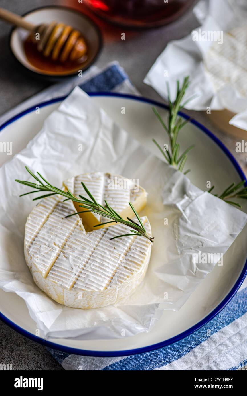 Ceramic plate with head of Brie cheese Stock Photo - Alamy