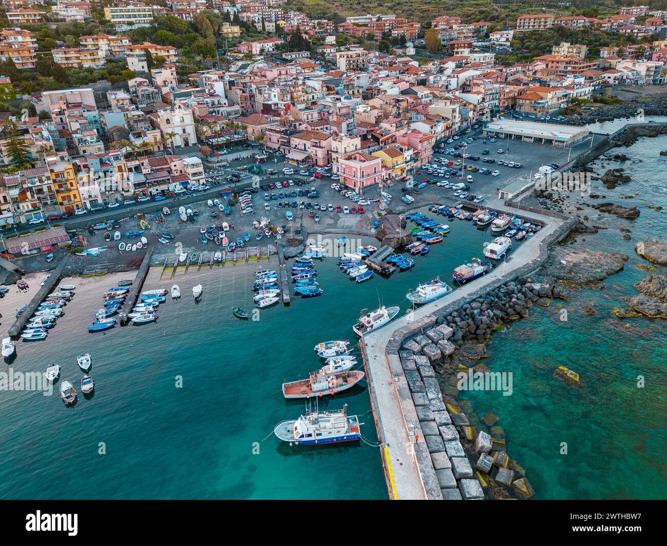 Aerial panorama of Acitrezza - colorful boats dotting the marina ...