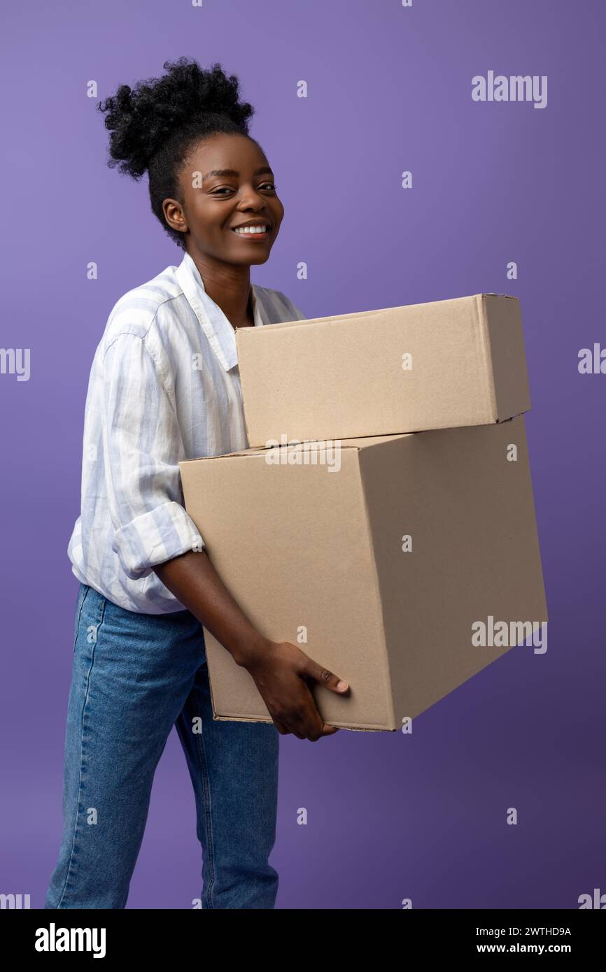 African american curly-haired girl with boxes on a violet background ...