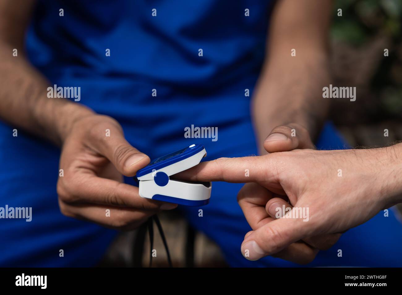Close up of doctors hands measuring patients pulse with pulsometer ...