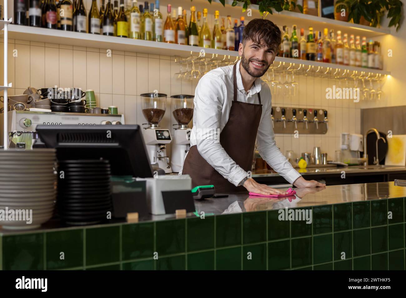 Caucasian male bartender wiping bar hi-res stock photography and images ...