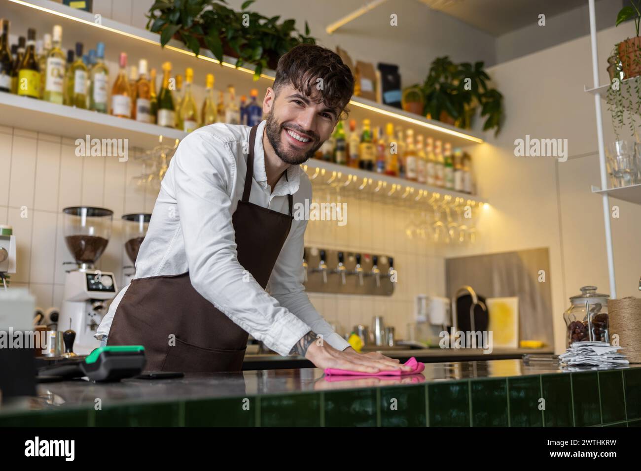 Caucasian male bartender wiping bar hi-res stock photography and images ...