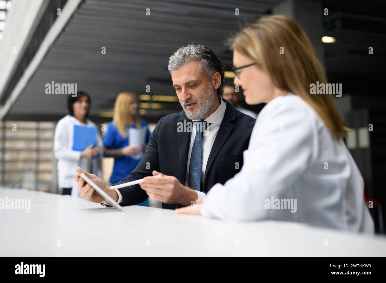 Doctor talking pharmaceutical representative hi-res stock photography ...