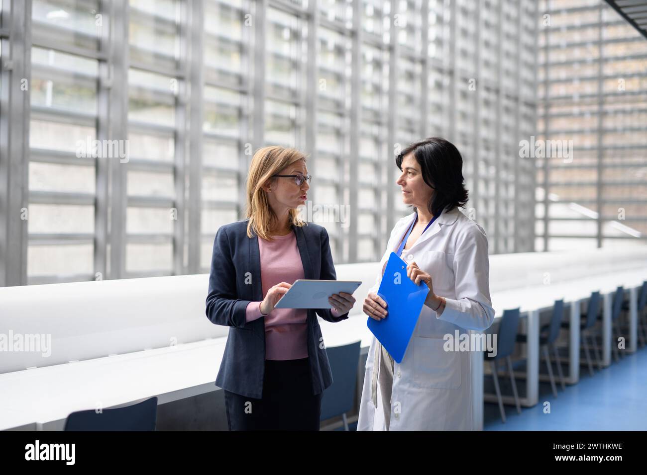 Doctor talking to pharmaceutical sales representative, presenting new ...