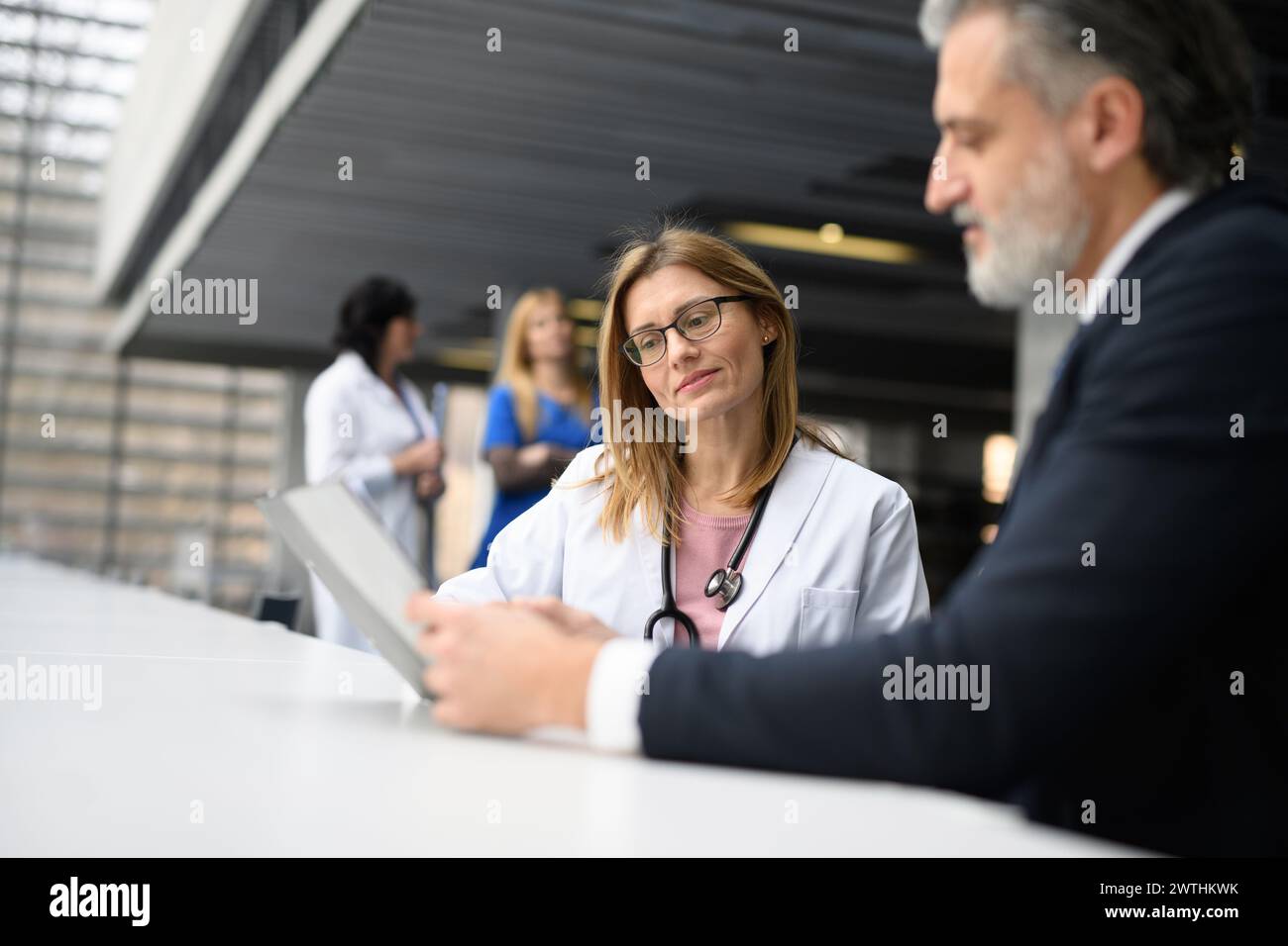 Doctor talking to pharmaceutical sales representative, shaking hands ...