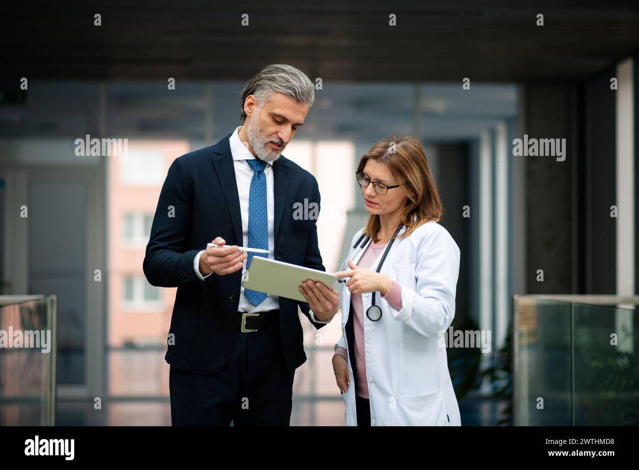 Doctor talking to pharmaceutical sales representative, presenting new ...