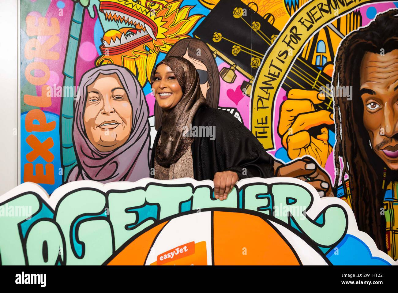 EDITORIAL USE ONLY Community hero Asha Rage in front of her portrait in ...