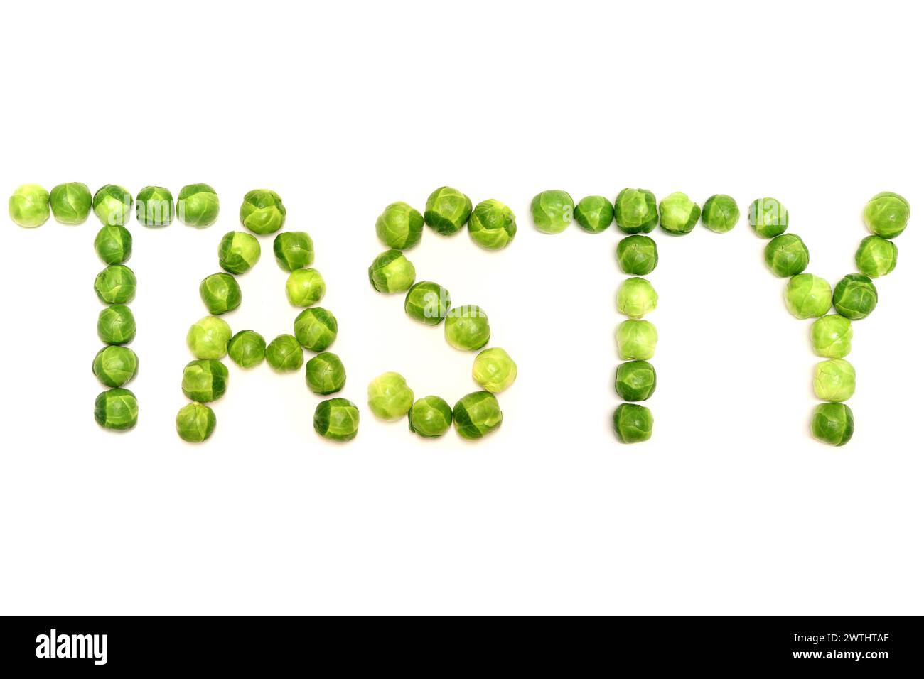 Brussel sprouts spelling the word tasty on a plain white background ...