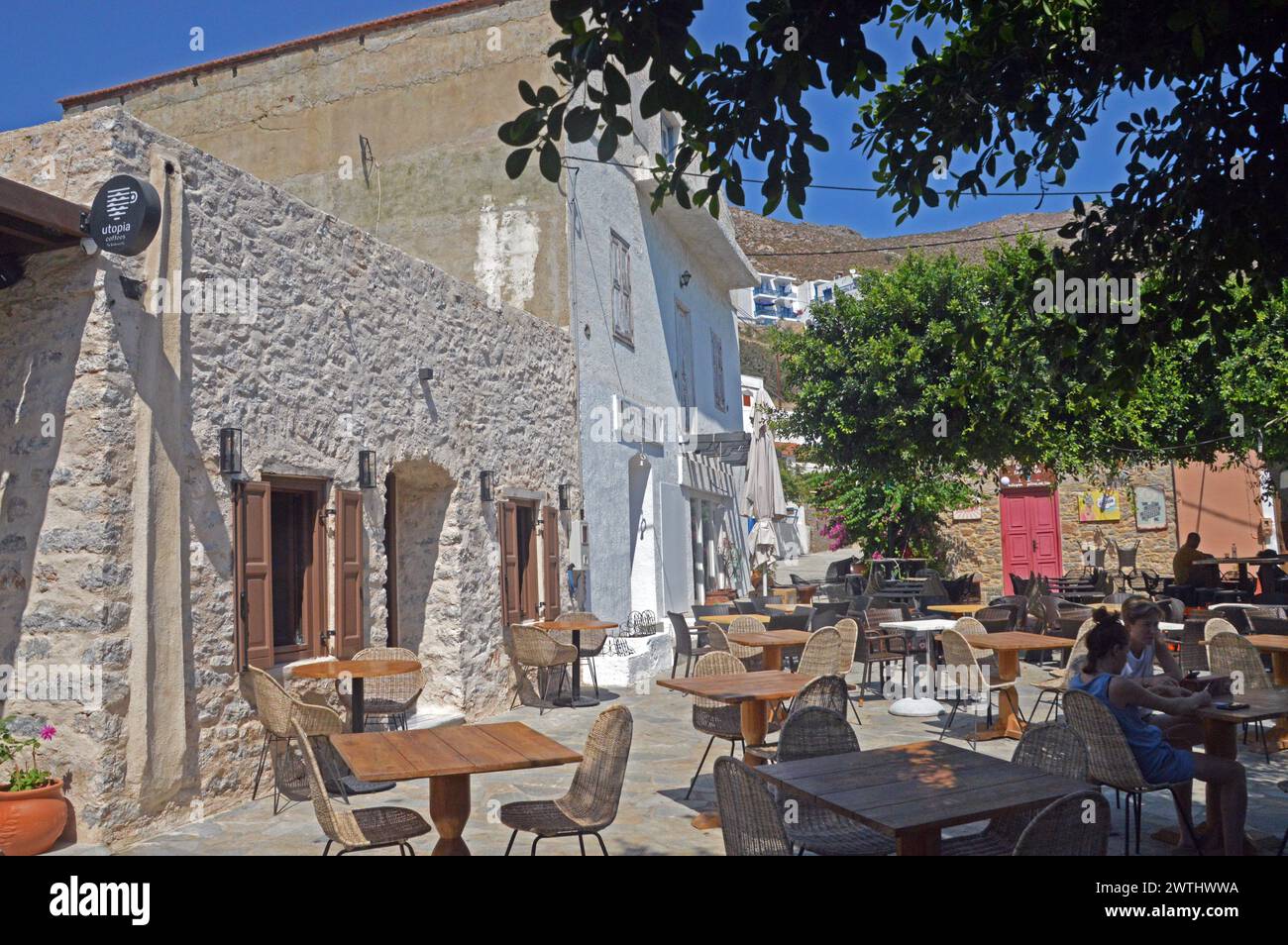 Greece, Island of Tilos: street restaurant in the town square of ...