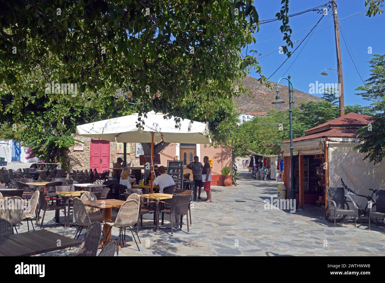 Greece, Island of Tilos: street restaurant in the town square of ...