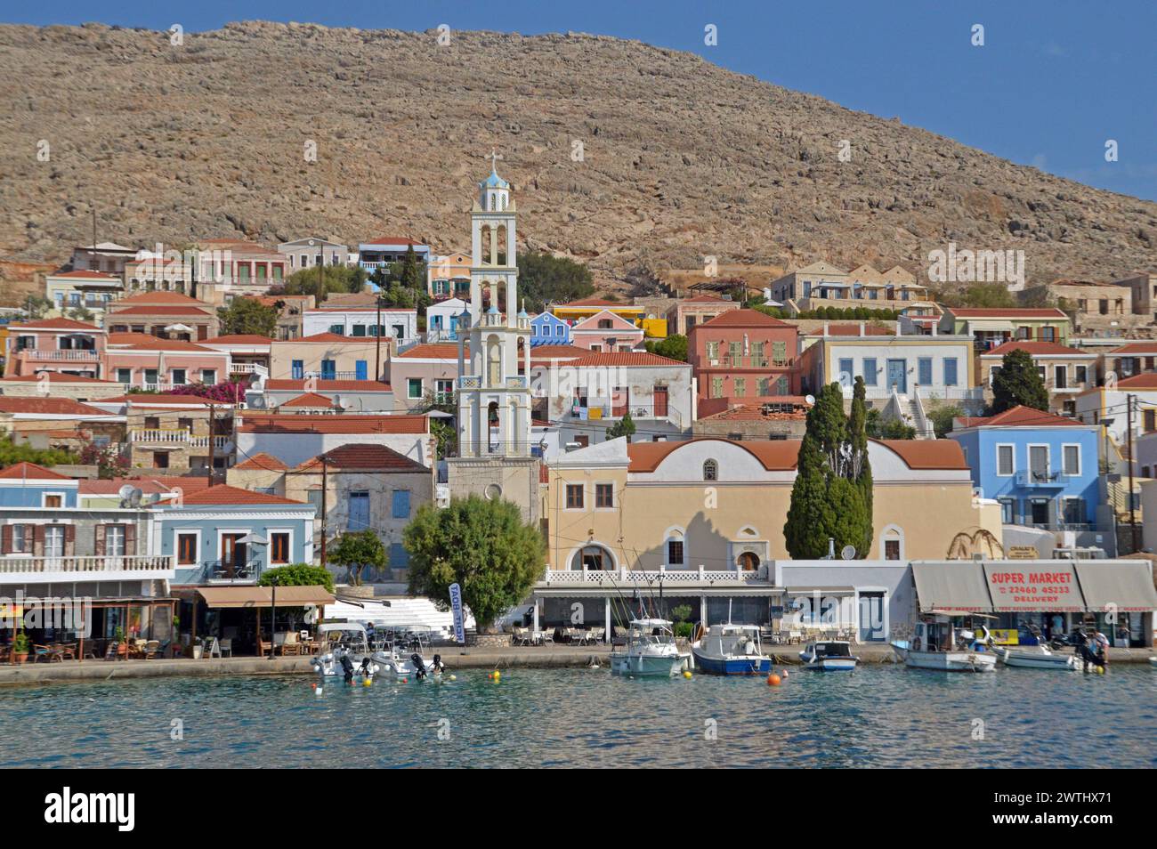 Greece, Island of Chalki: the promenade and waterfront, with house ...