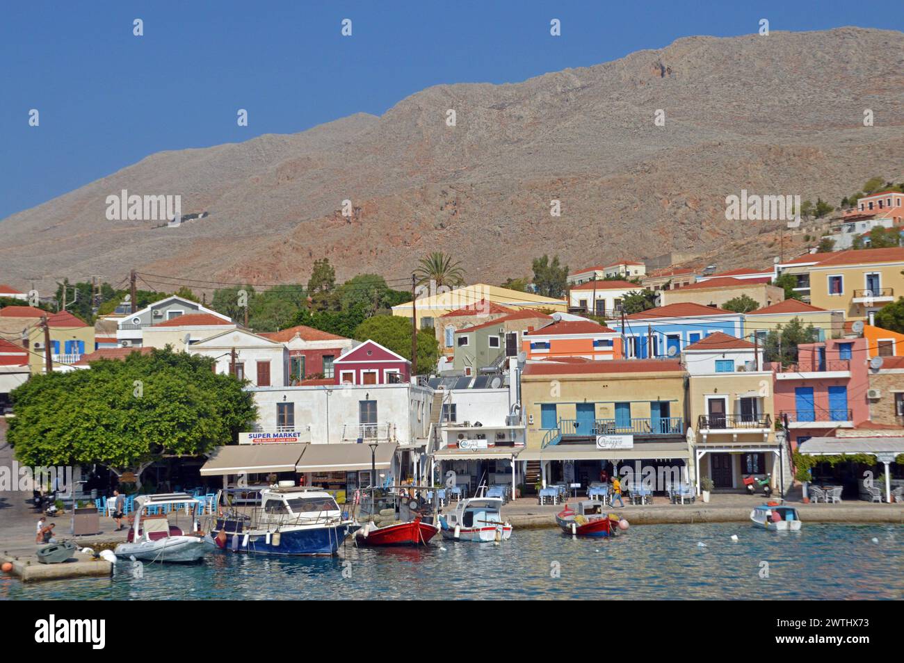Greece, Island of Chalki: the promenade and waterfront, with house ...