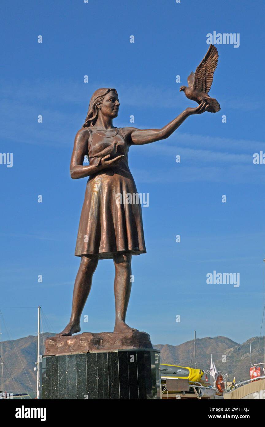 Turkey, Mugla, Marmaris: statue of a girl with dove on the quayside ...