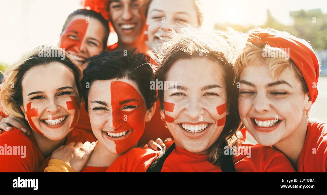 Crazy sport fans smiling on camera while supporting their team ...