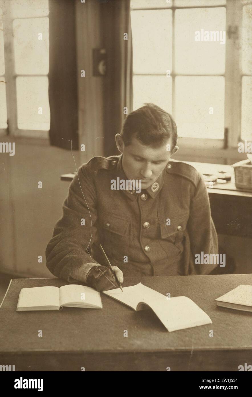 WWI soldier Allan McMillan writing at a desk at Oatlands Park, Surrey ...