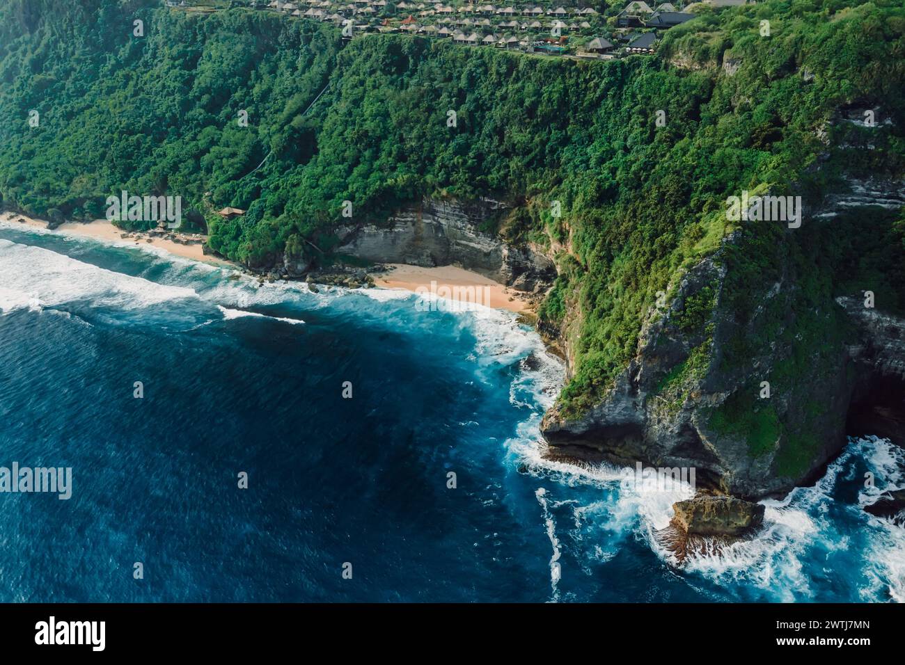 Scenic landscape with rocky coastline and blue ocean with waves in ...