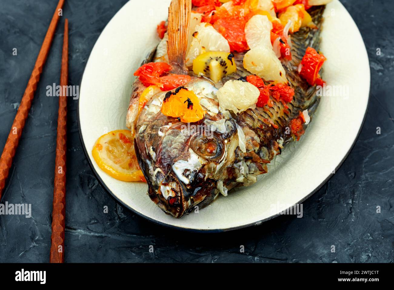 Fried tilapia fish with fruit. Healthy food concept Stock Photo - Alamy
