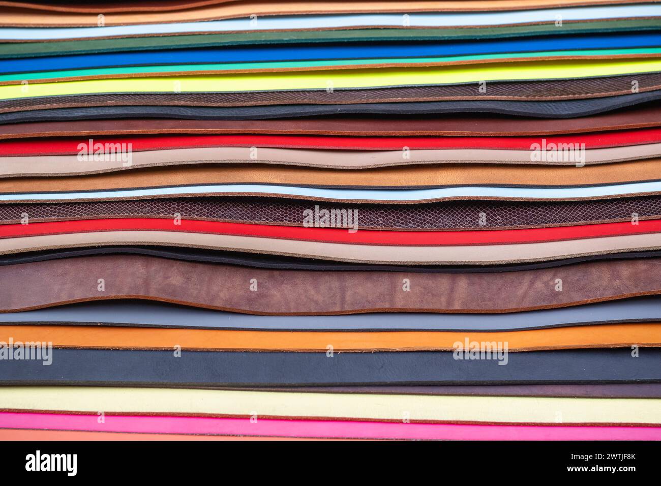 Selection of coloured or tanned leather on display at Camden market in ...