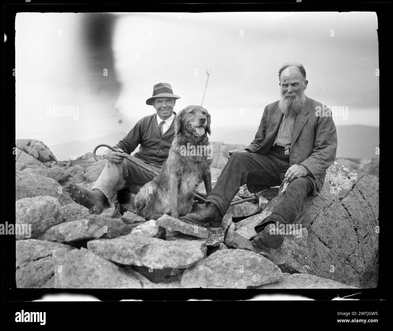 Two people black dog Black and White Stock Photos & Images - Alamy