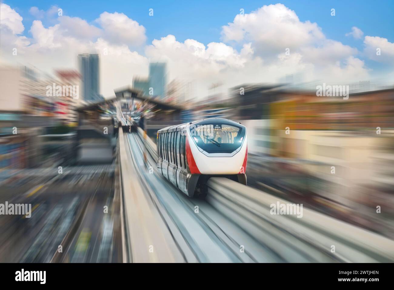 High speed monorail train with bright headlights passes race station on ...