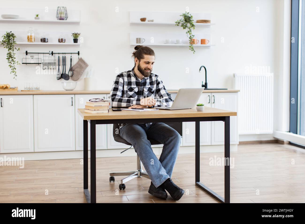 Positive entrepreneur discussing company issues using computer in ...