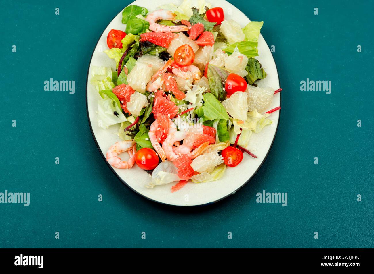 Pomelo salad with shrimp, tomato cherry and lettuce. Concept of healthy ...
