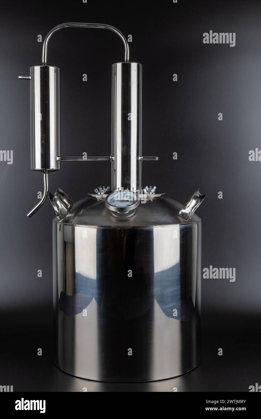 brand new stainless steel alcohol machine on black background Stock ...