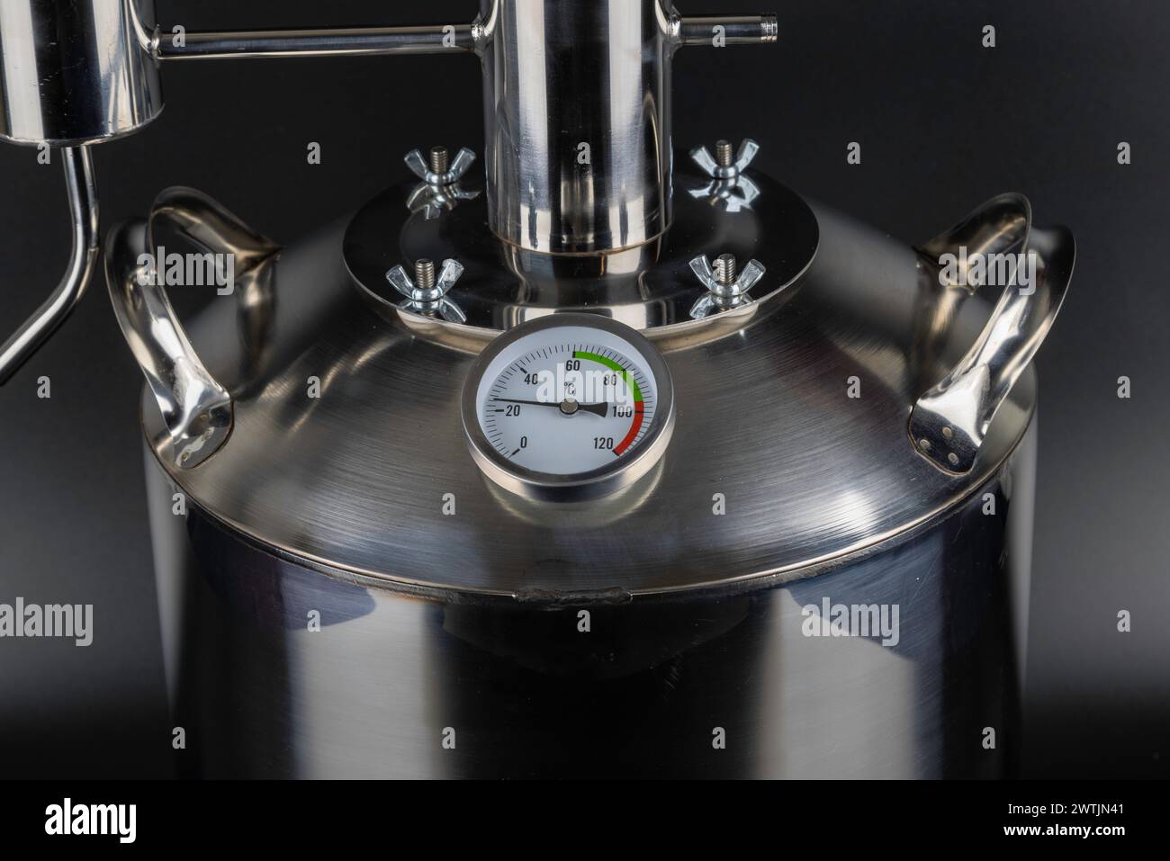 brand new stainless steel alcohol machine on black background Stock ...