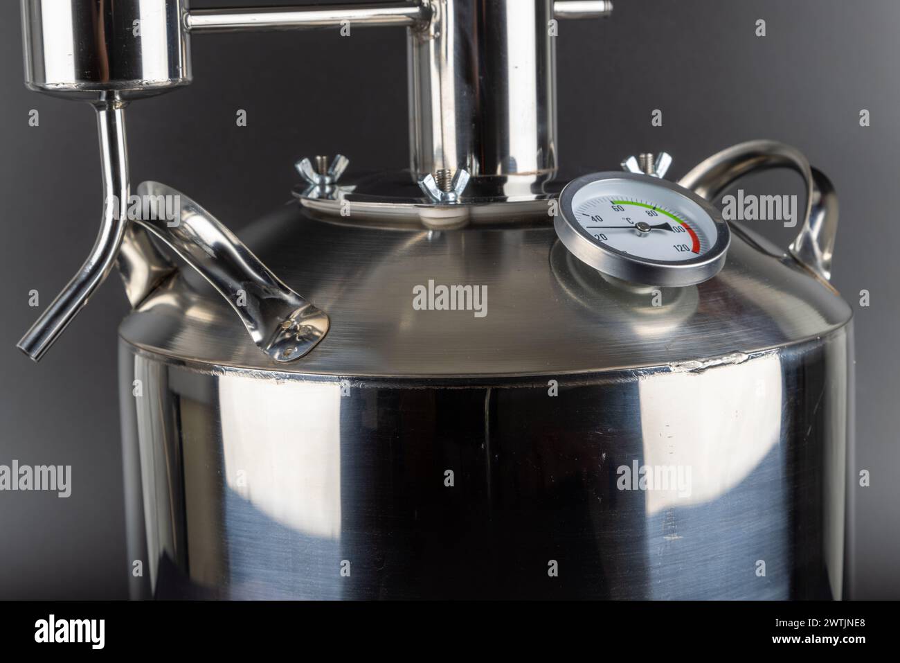 brand new stainless steel alcohol machine on black background Stock ...