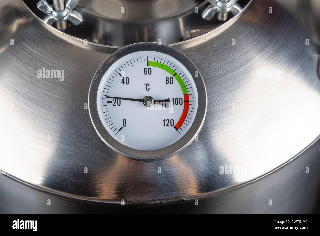 brand new stainless steel alcohol machine on black background Stock ...