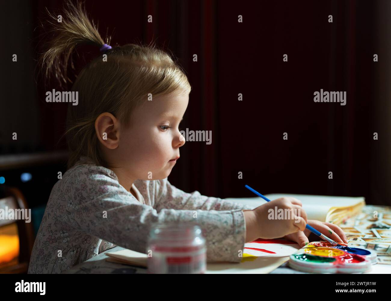 A young baby artist painting with watercolors. Adorable blonde girl of ...