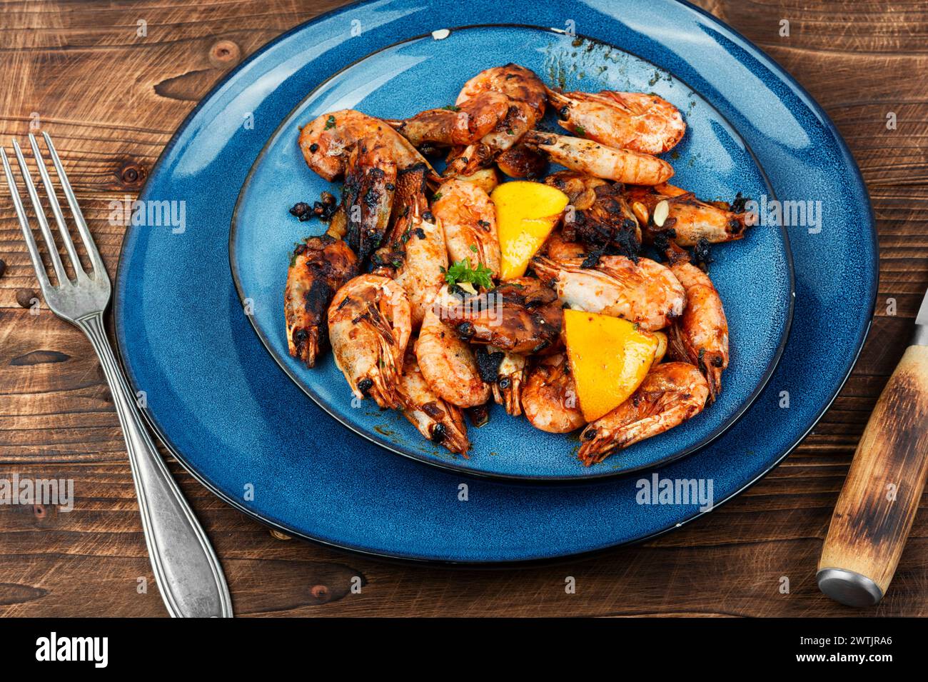 Roasted unpeeled shrimp on a plate. Grilled prawns or shrimps, seafood Stock Photo - Alamy