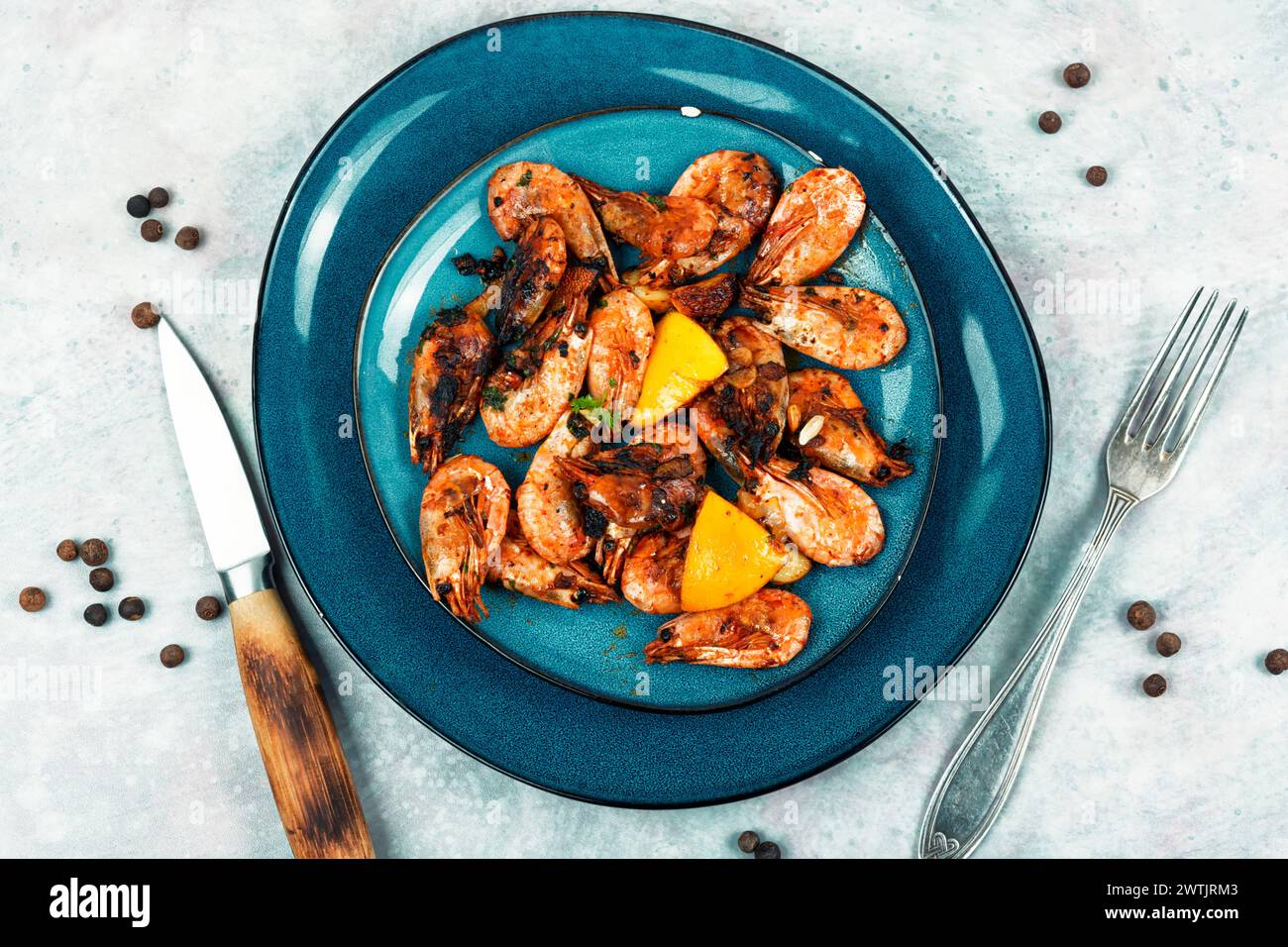 Roasted unpeeled shrimp on a plate. Top view Stock Photo - Alamy
