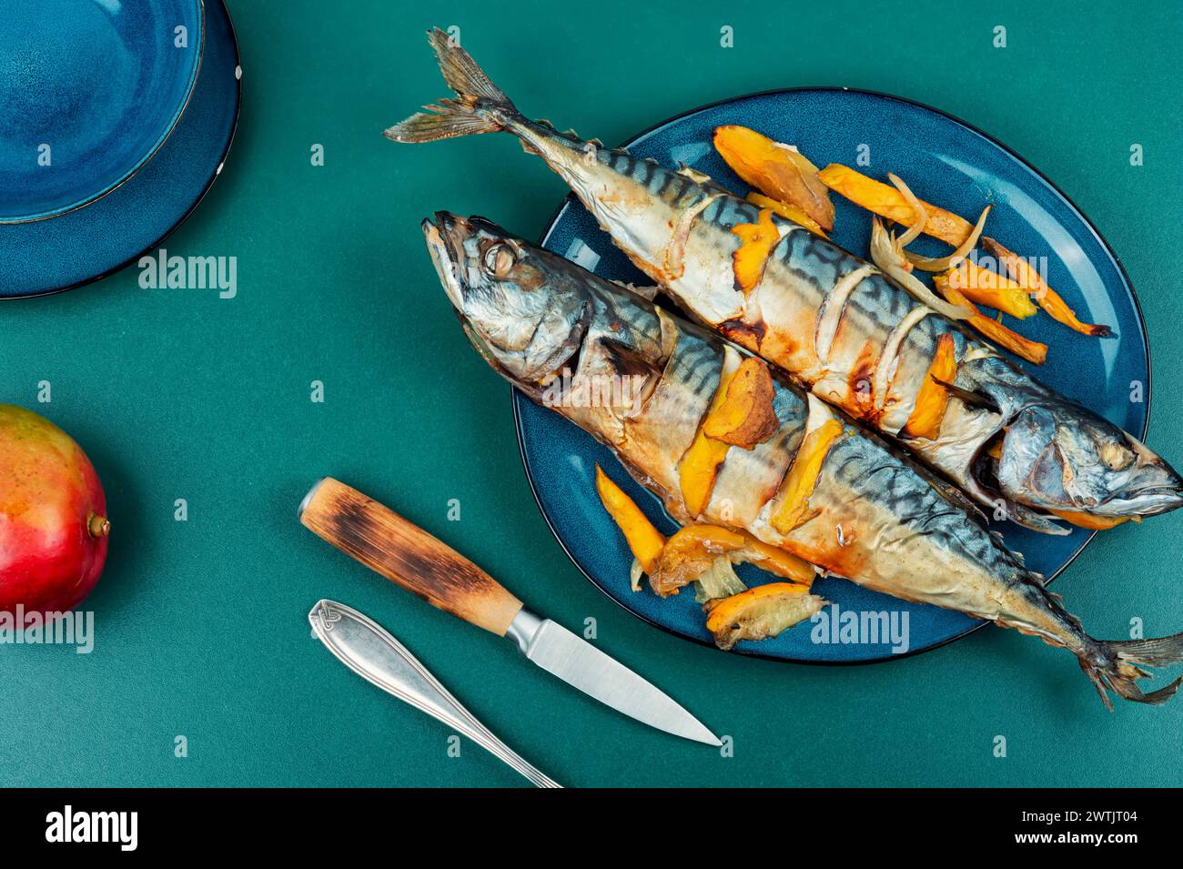 Appetizing mackerel fish roasted with mango. Food recipe background ...