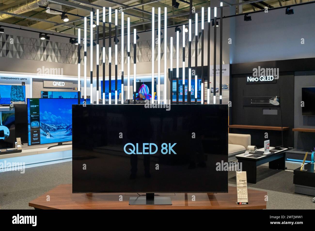 8K TV in modern electronics store. Samsung QLED 8K TV in a shop window ...