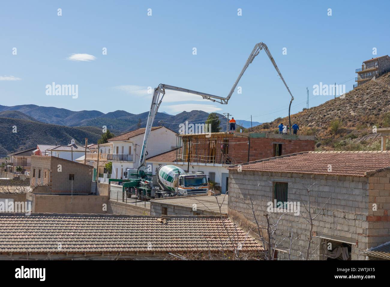 Concrete Boom Pump Pouring Concrete Onto The Upper Floor Of A New Build ...
