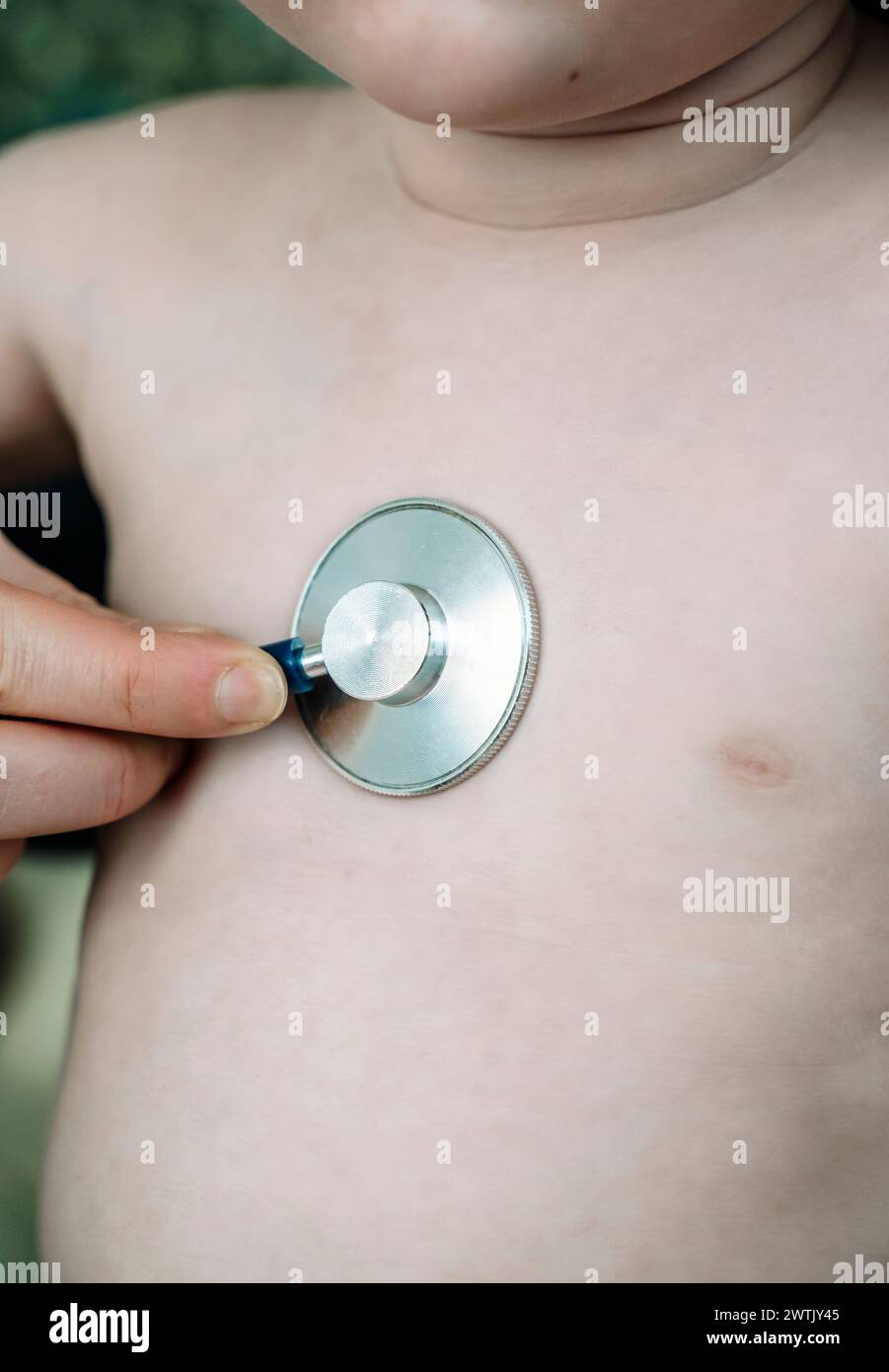 A pediatrician listens to a baby with a stethoscope in the clinic ...