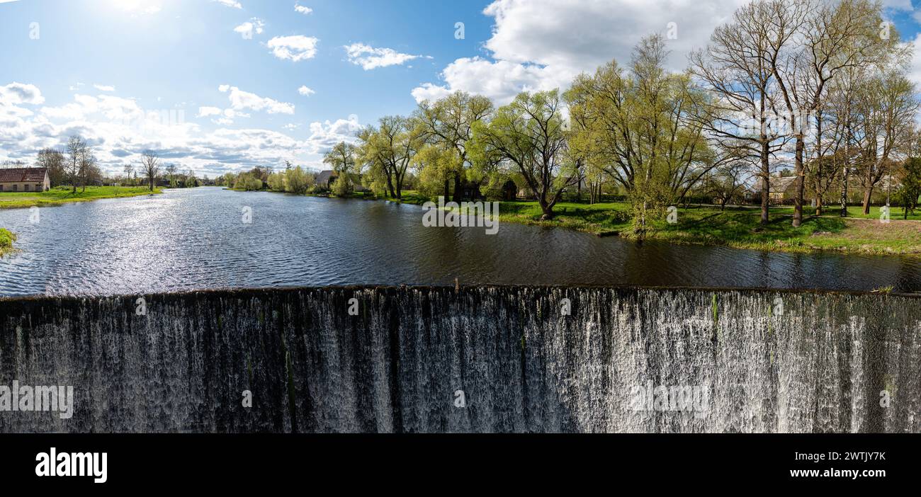 Water flows from a small semi-circular dam in a small village by the ...