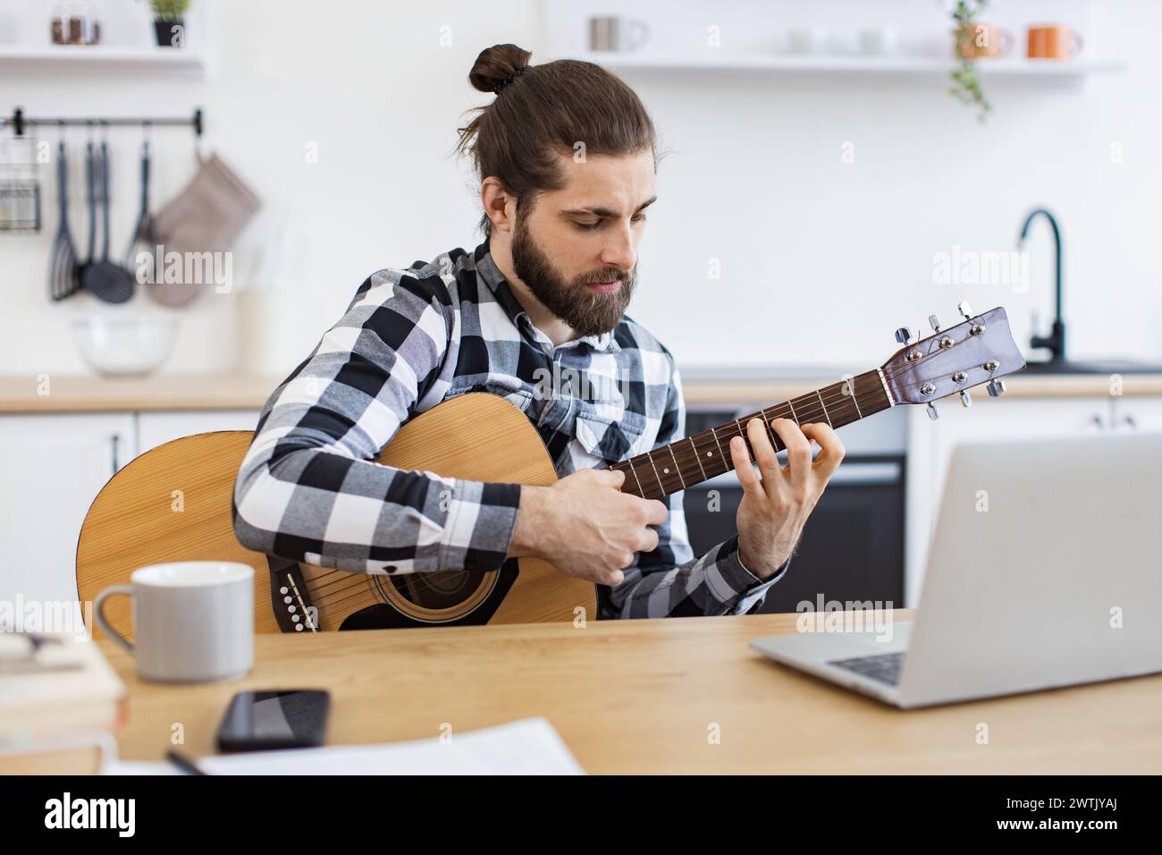 Happy male teaching online guitar lesson using modern technologies ...