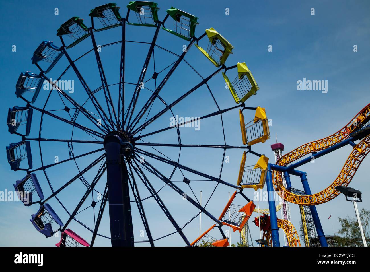 Colorful rides in motion in amusement park on sky background Stock ...