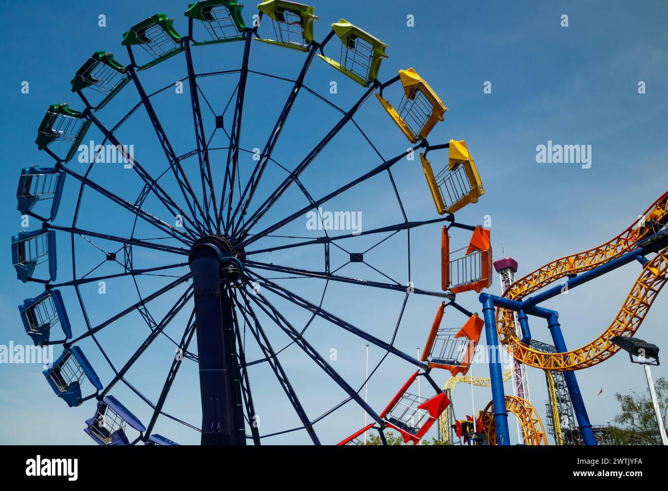 Colorful rides in motion in amusement park on sky background Stock ...
