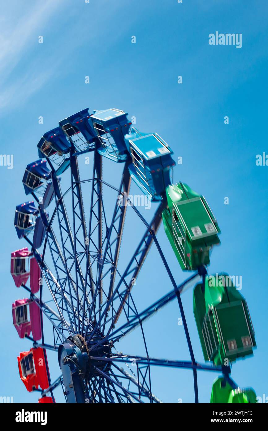 Colorful ride in motion in amusement park on sky background Stock Photo ...