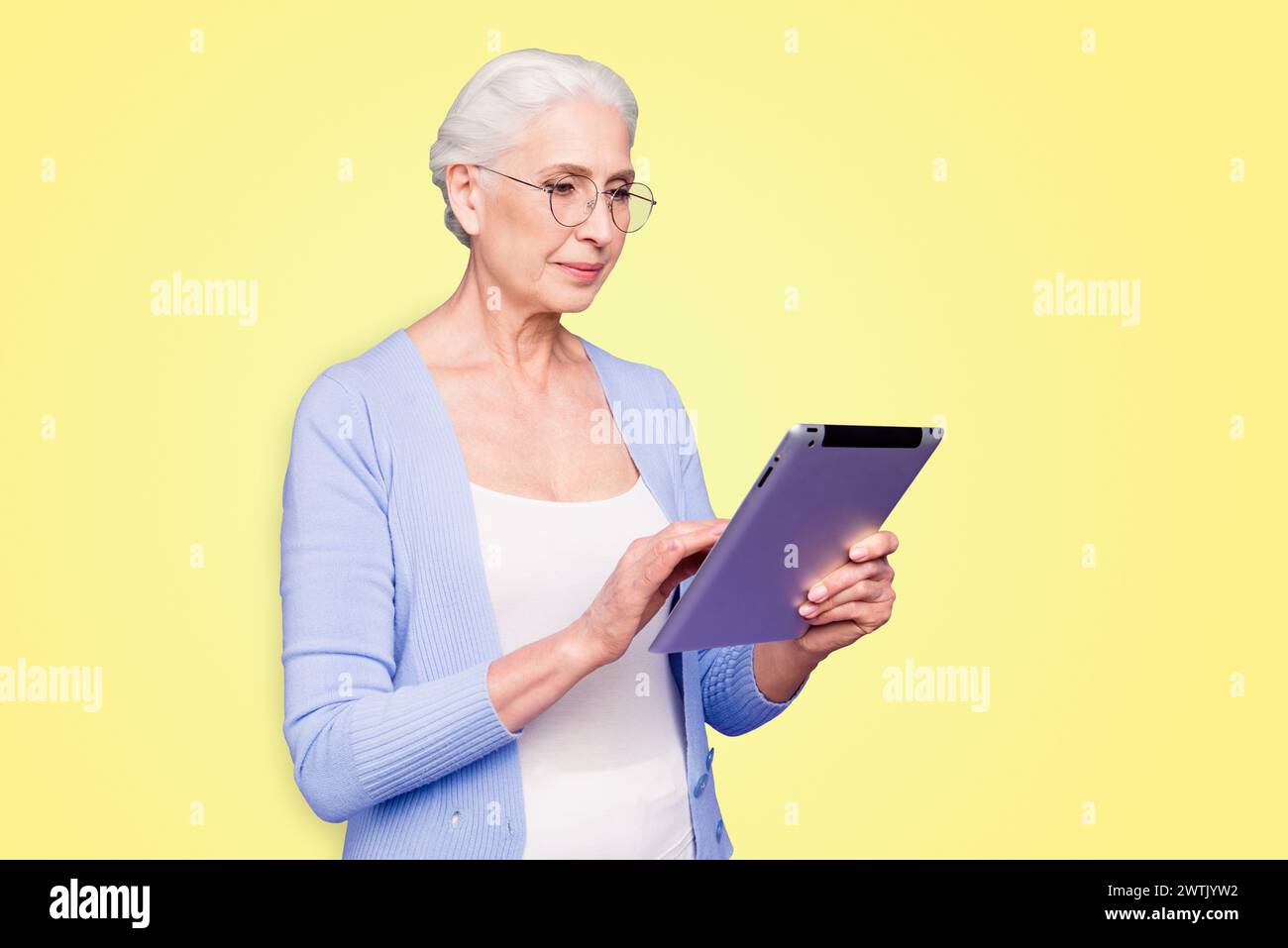 Grey haired old serious business woman wearing glasses, reading ...