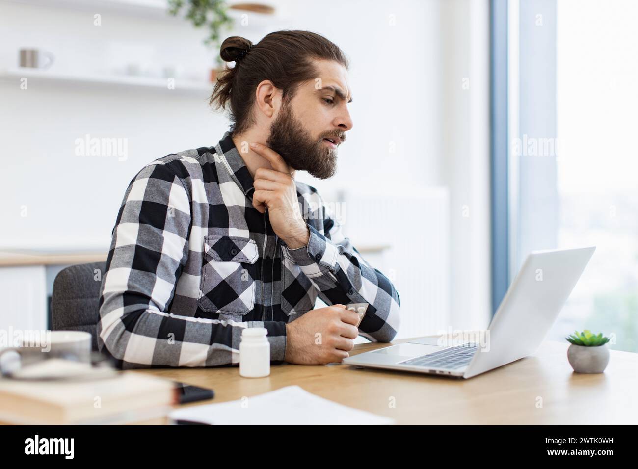 Caucasian employee working remotely from home while fighting illness ...
