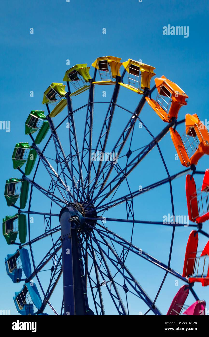 Colorful ride in motion in amusement park on sky background Stock Photo ...